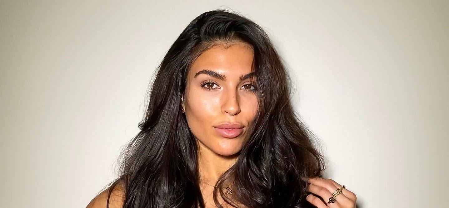 Emily Faye Miller Hits The Beach In A Tight-Fitting White Dress